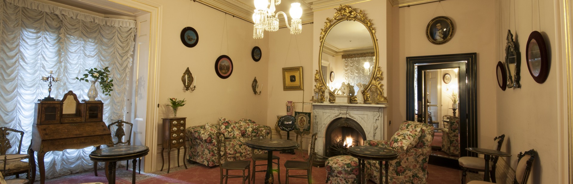 “The lofty-ceilinged ballroom room blazed with light from the ...